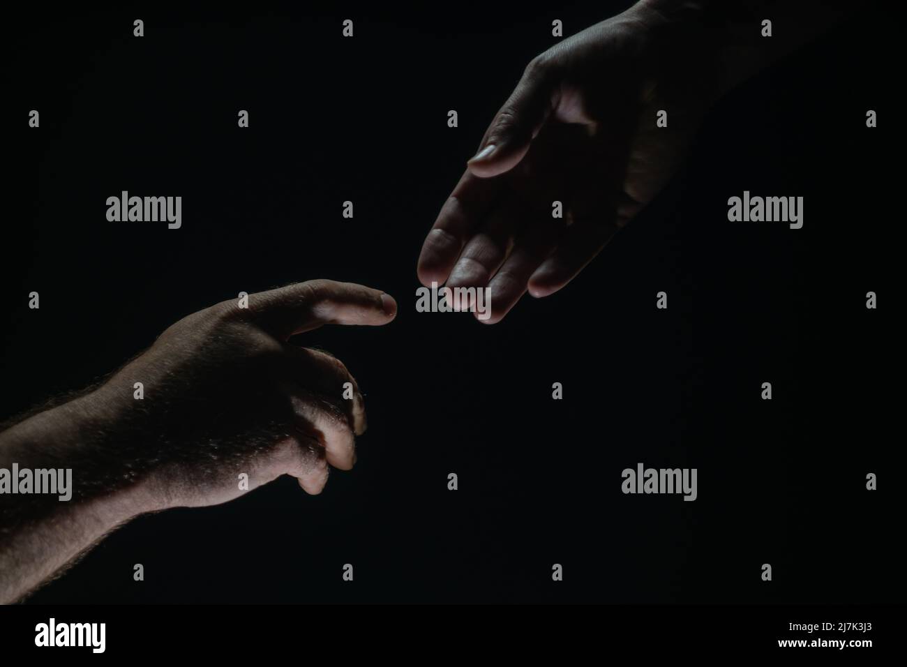 Men holding hands isolated on black. Connection and human relations ...