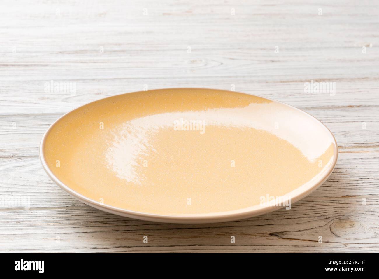 Perspective view of empty orange plate on cement background. Empty ...