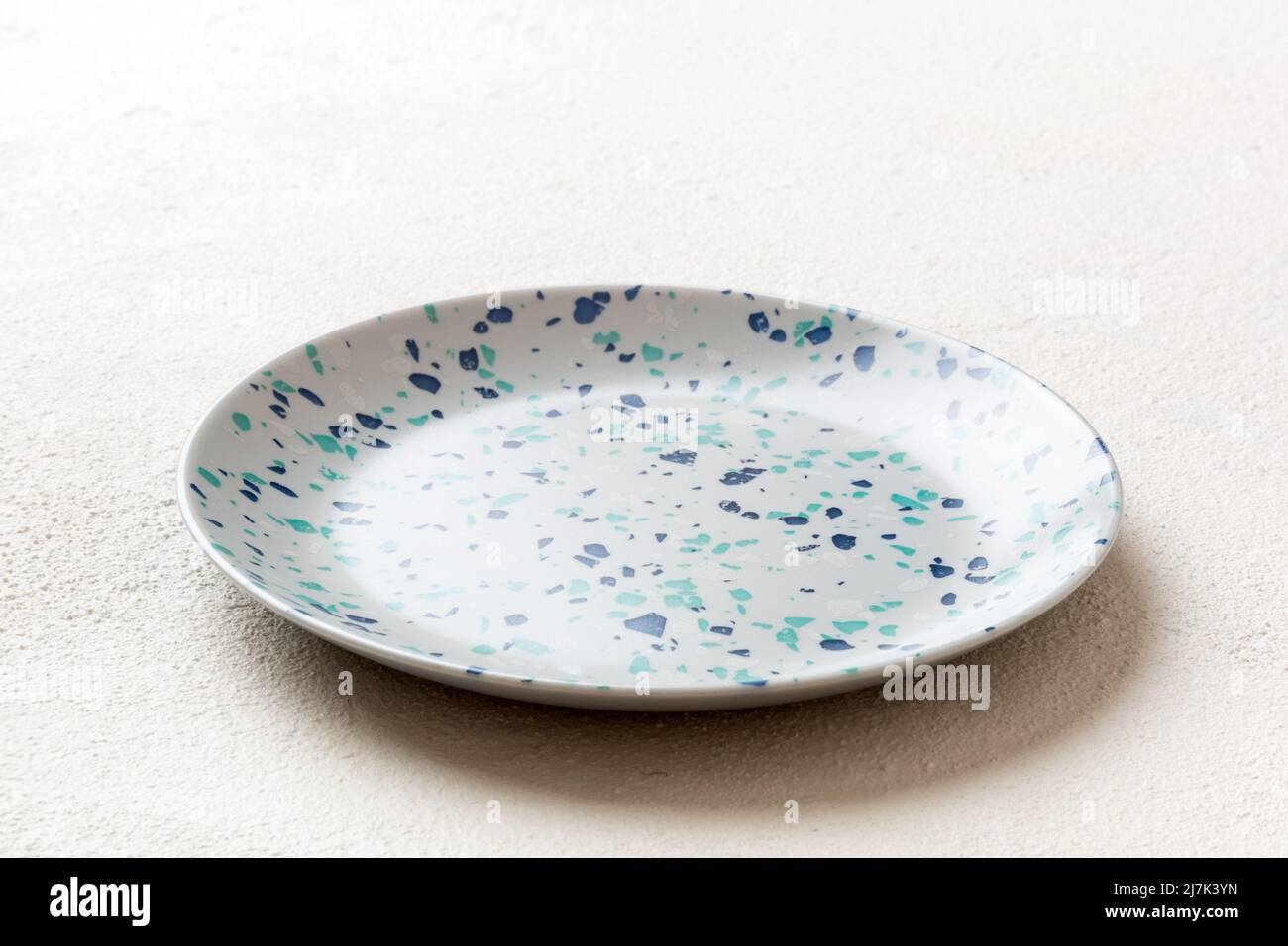 Perspective view of empty colorful plate on cement background. Empty ...