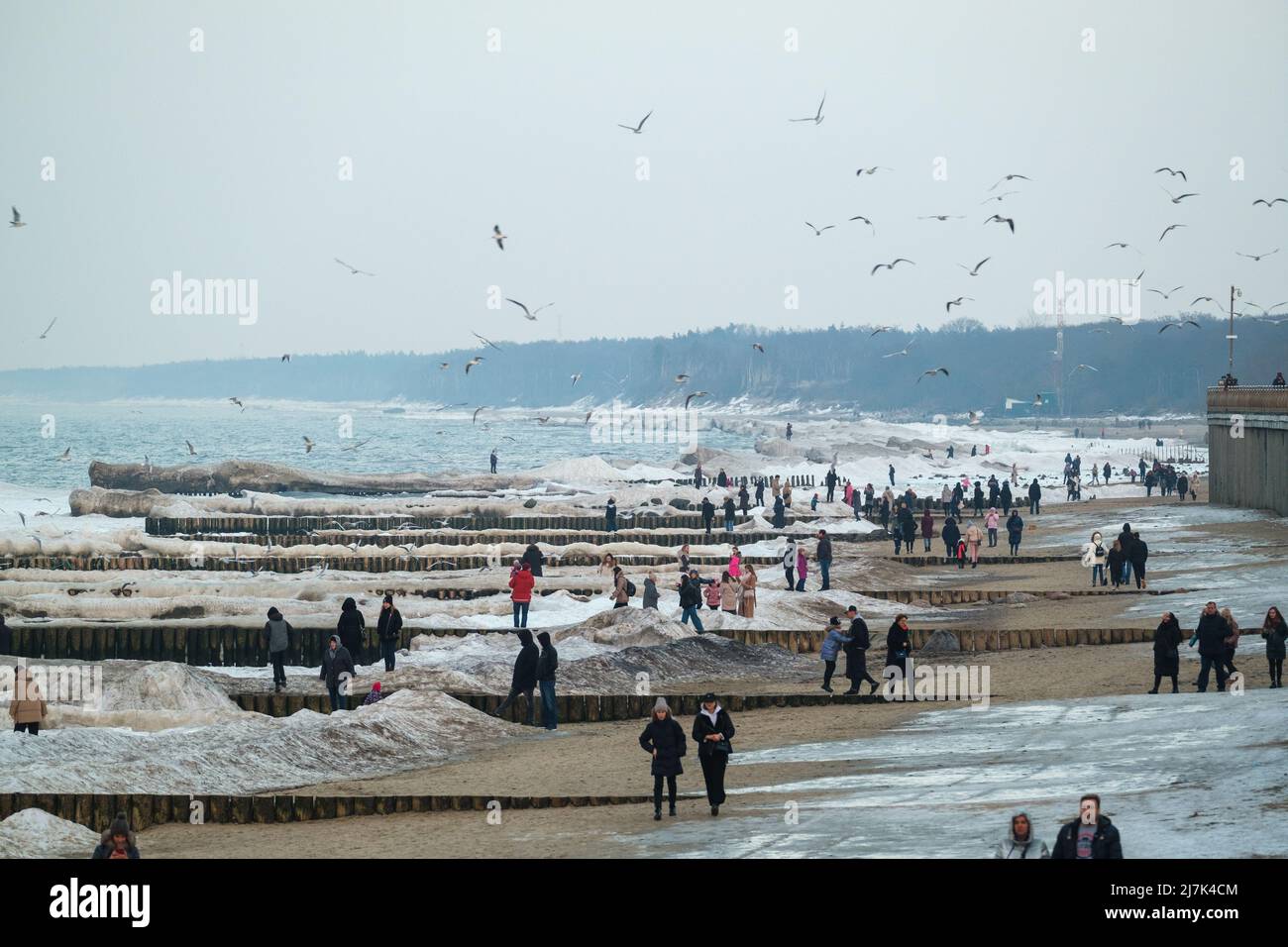 People walking on frozen sea embankment Stock Photo - Alamy