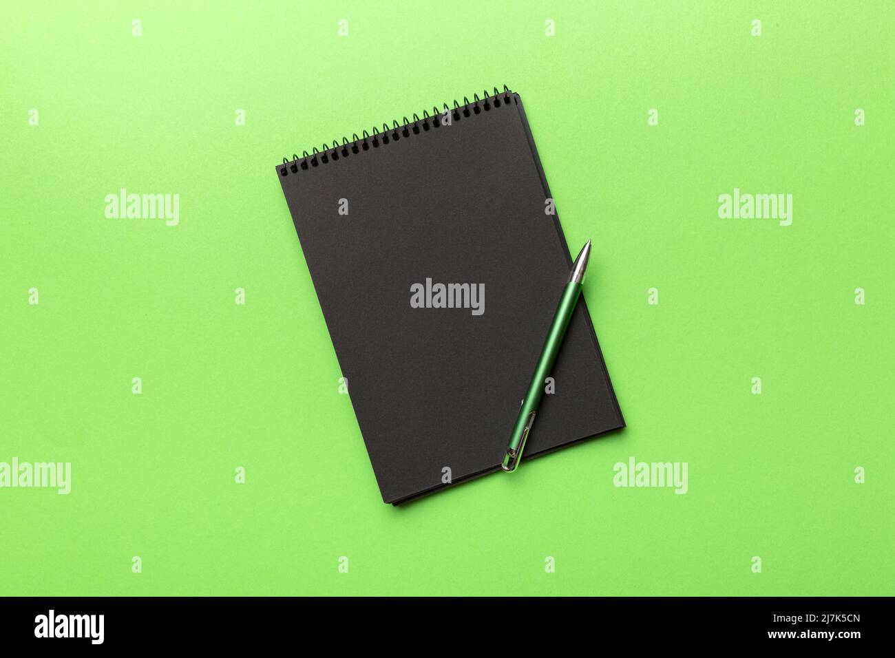 school notebook on a colored background, spiral black notepad on a ...