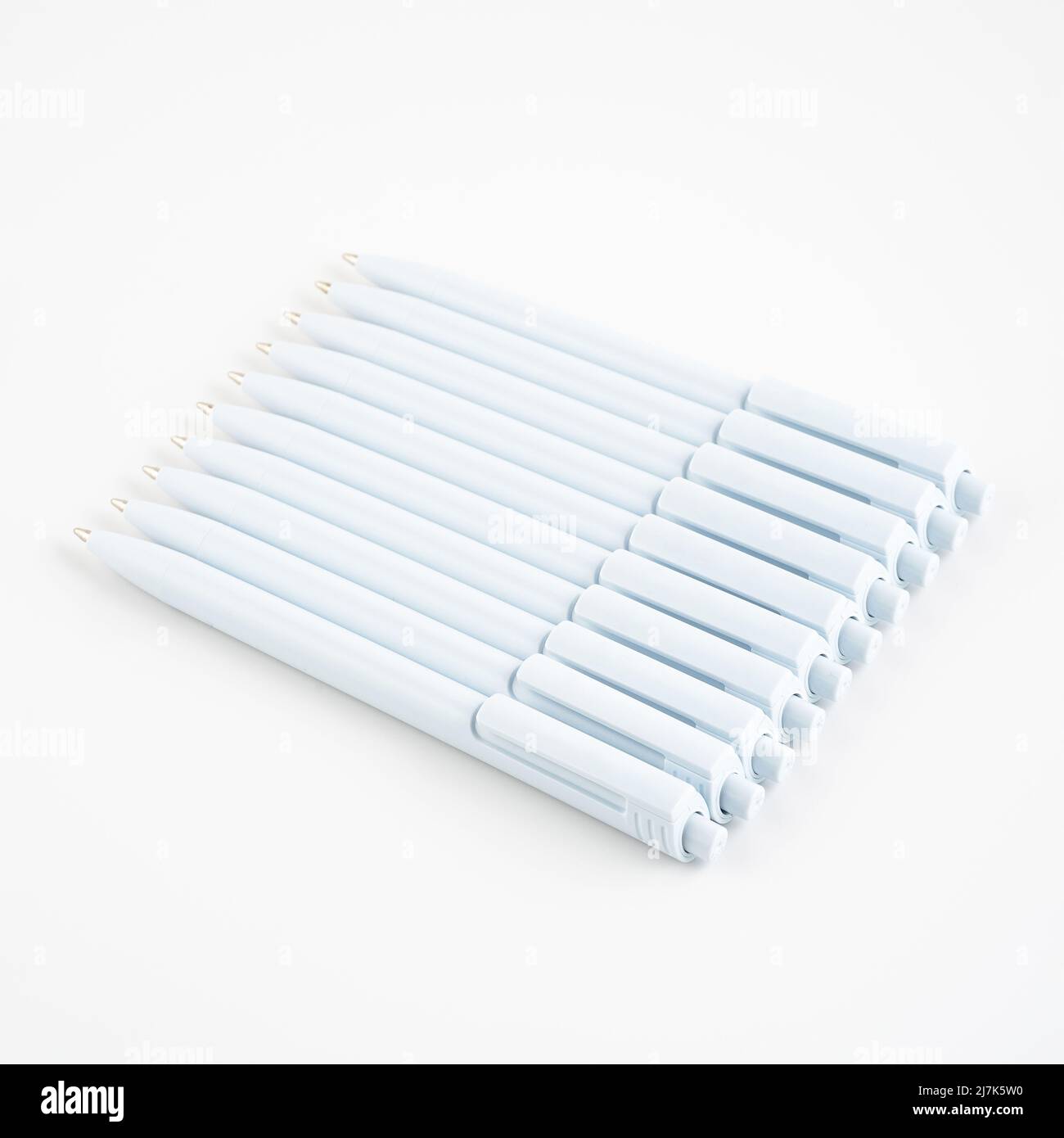 Set of white pens on a white background. Monochromatic image of ...