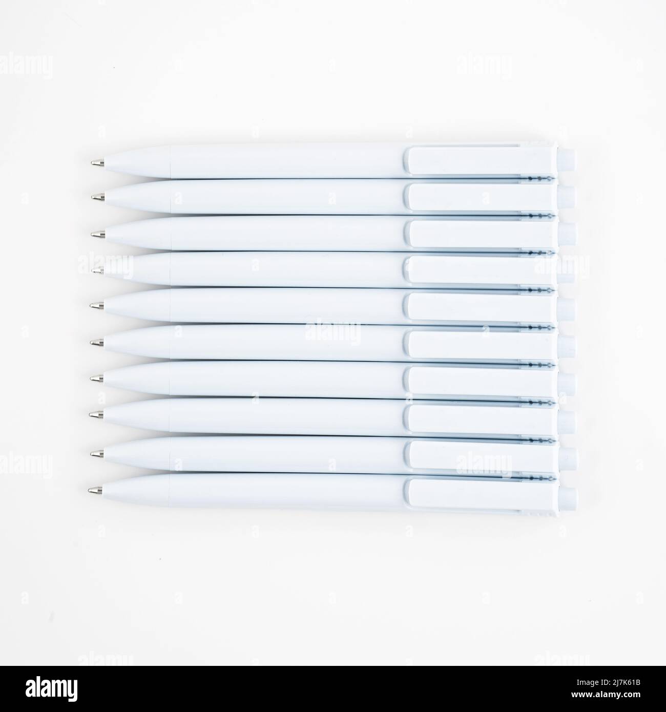 Set of white pens on a white background. Monochromatic image of ...