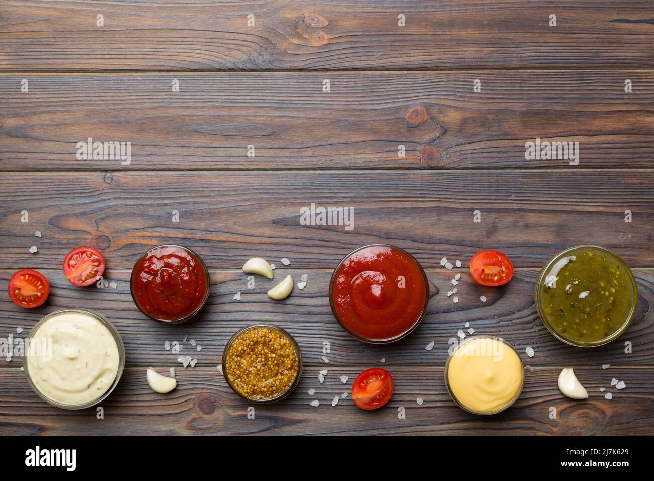 Many different sauces and herbs on table, flat lay top view. sauces ...