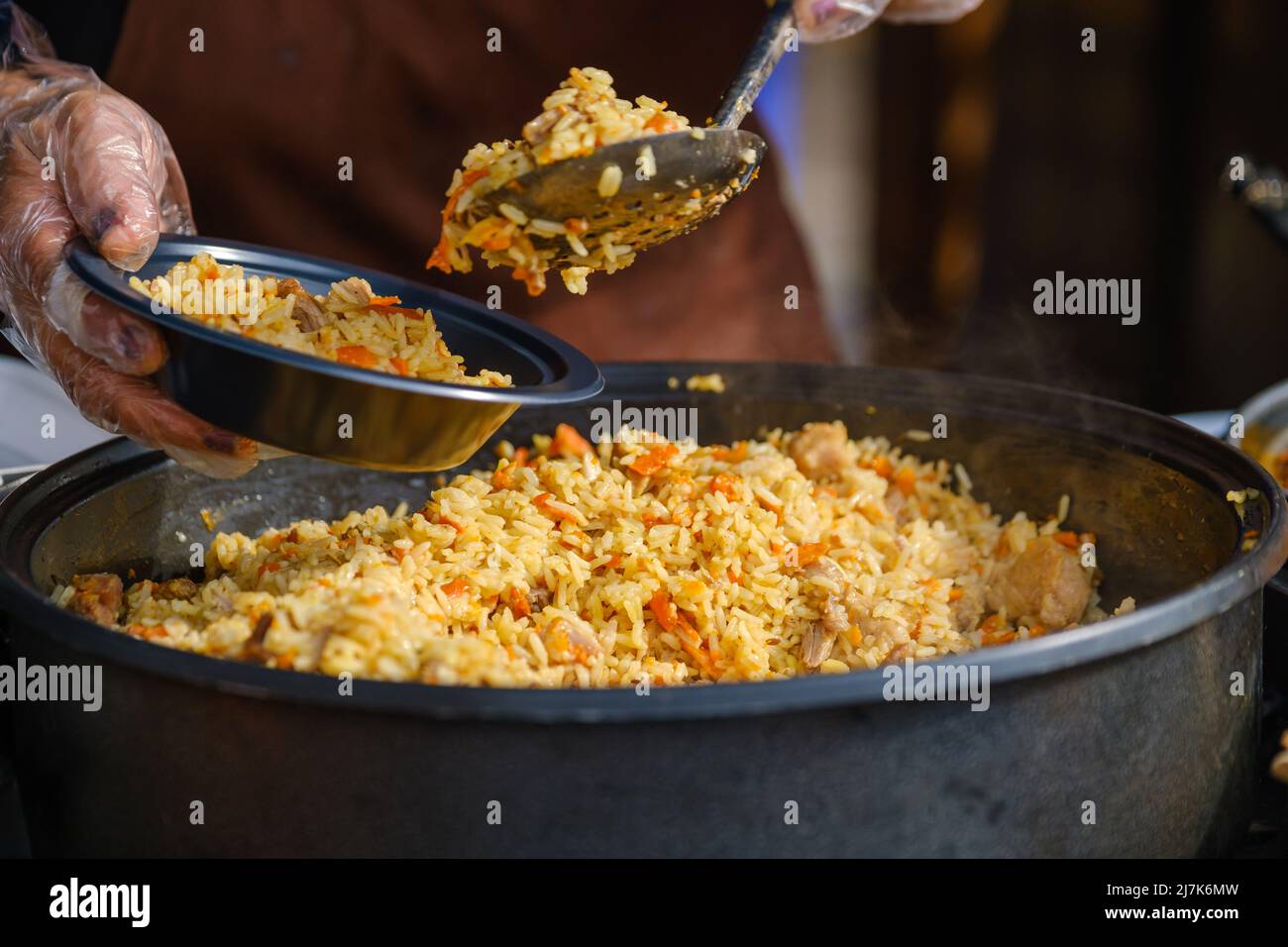 Crop cook serving delicious pilaf Stock Photo - Alamy