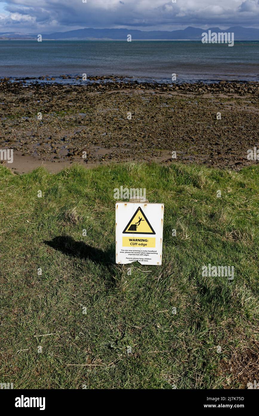 Yellow and white Danger cliff edge warning sign on wales coast path ...