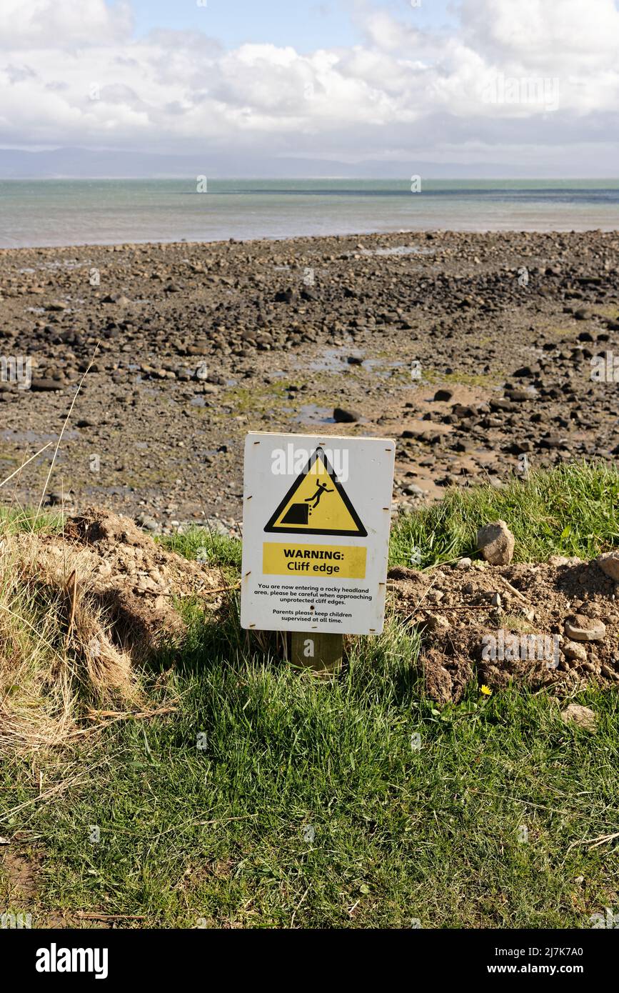 Yellow and white Danger cliff edge warning sign on wales coast path ...