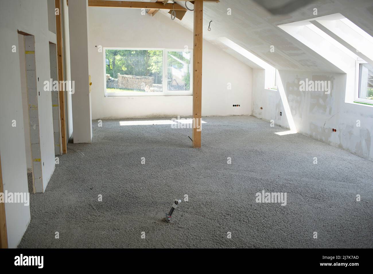 Construction site of attic conversion in the phase of floor screed fill ...