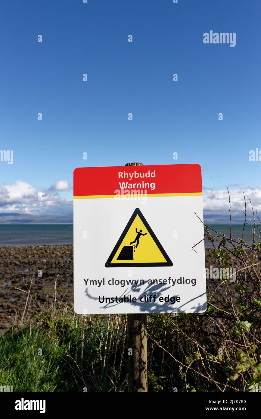 Red and white bilingual welsh and english unstable cliff edge warning ...