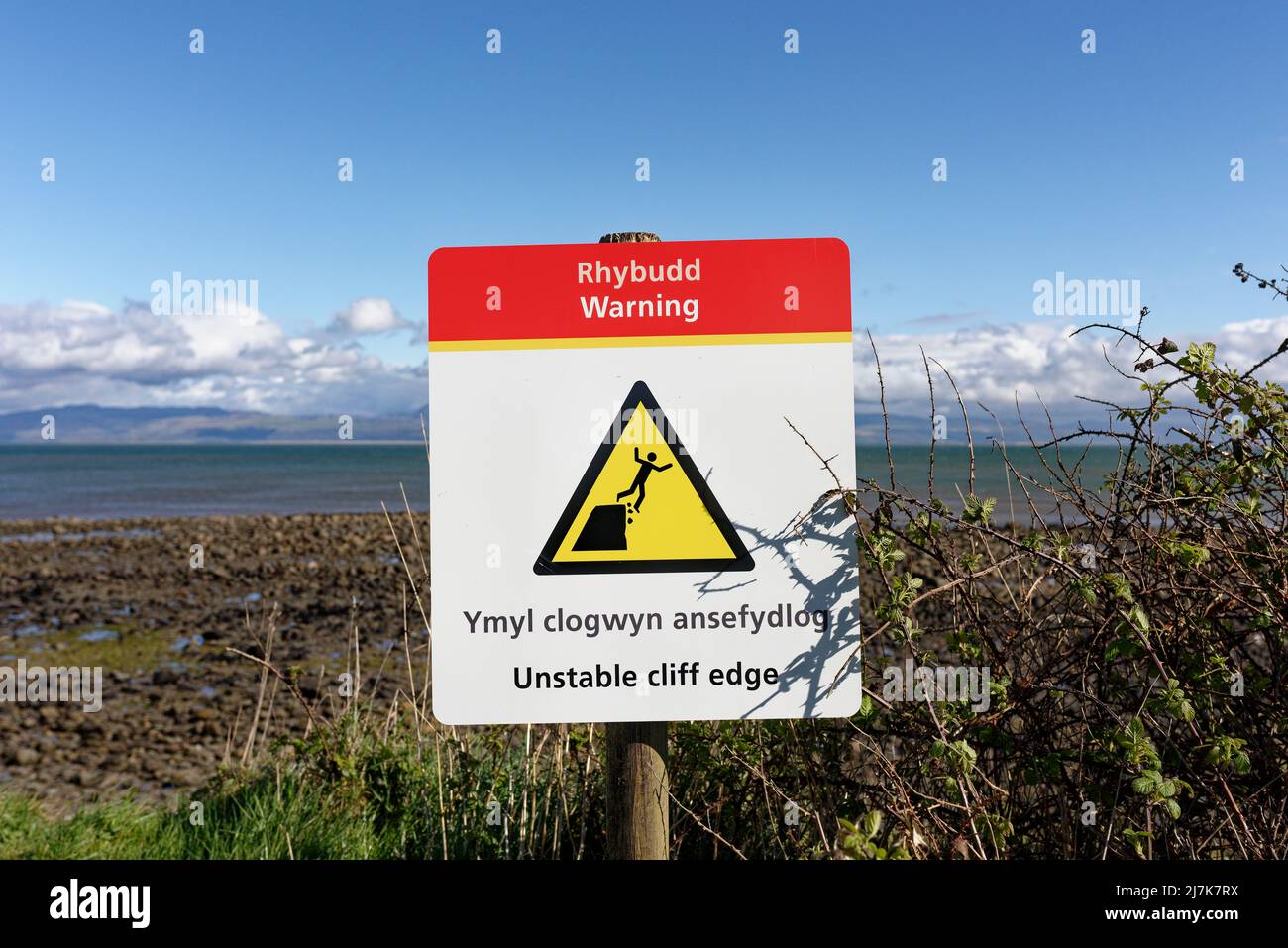 Red and white bilingual welsh and english unstable cliff edge warning ...