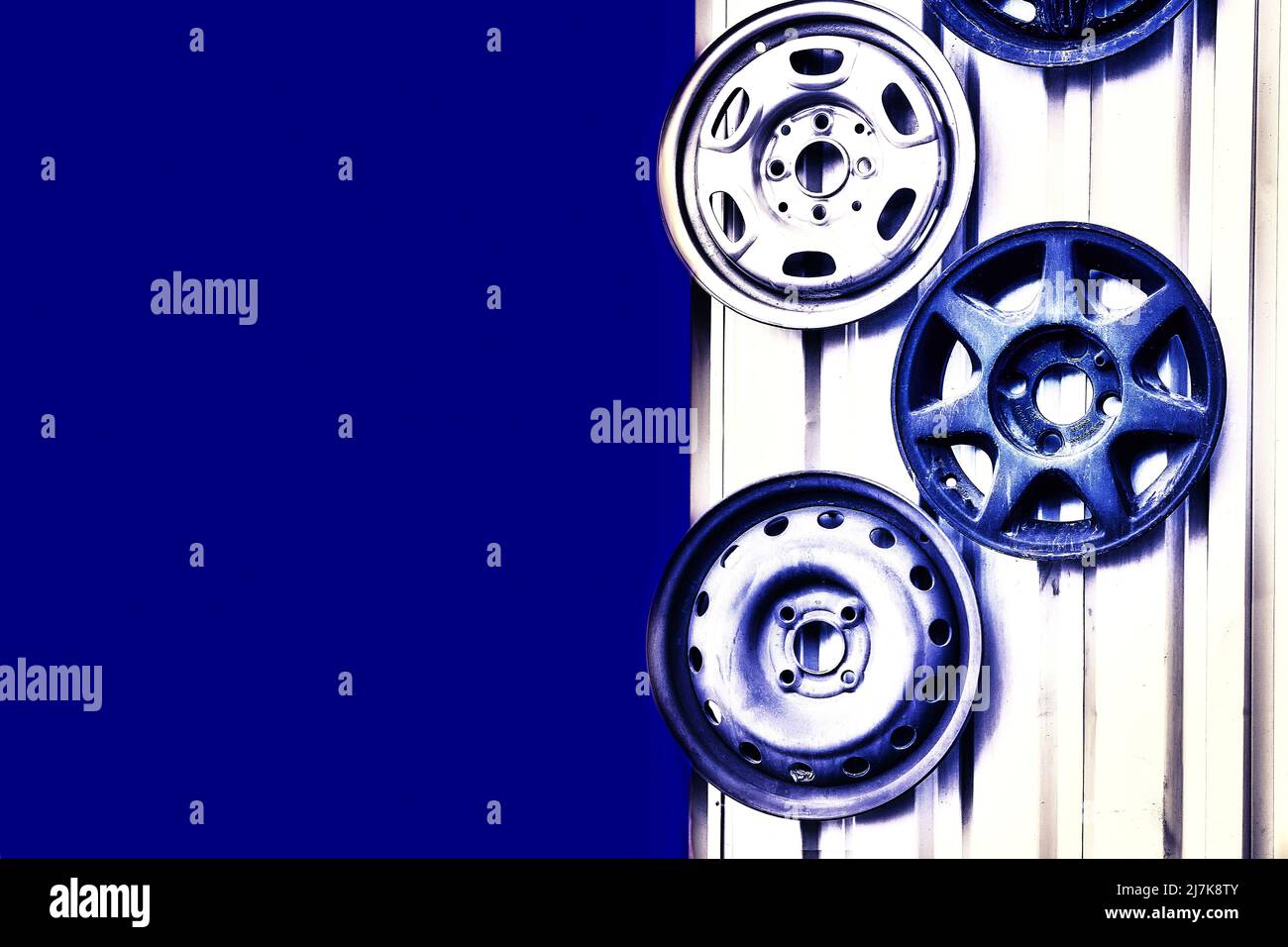 Three metal car rims hanging on the wall with space for text Stock ...