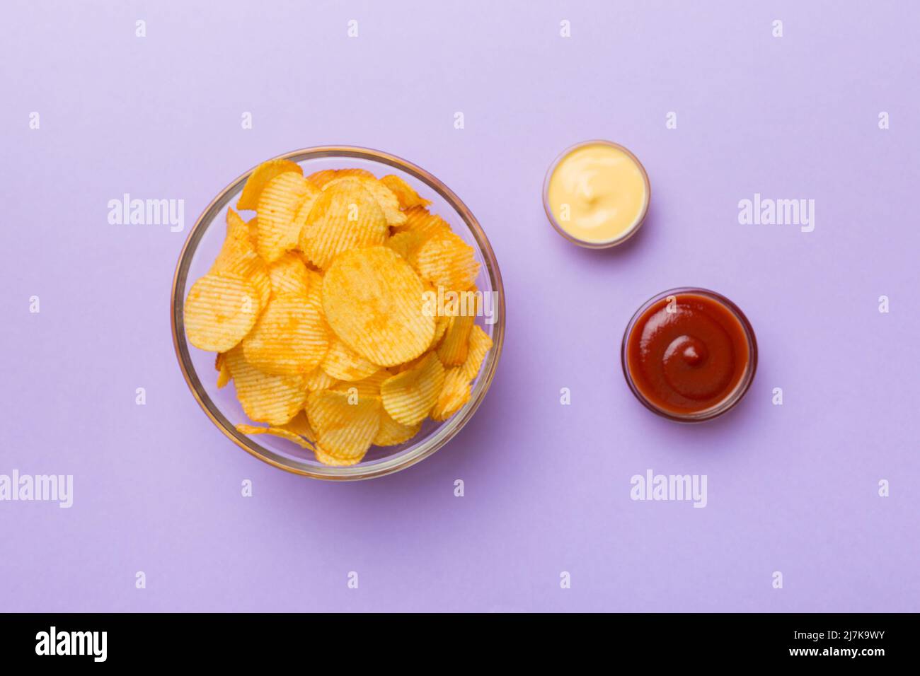 Top view chips with sause in bowl on colored background, top view with ...