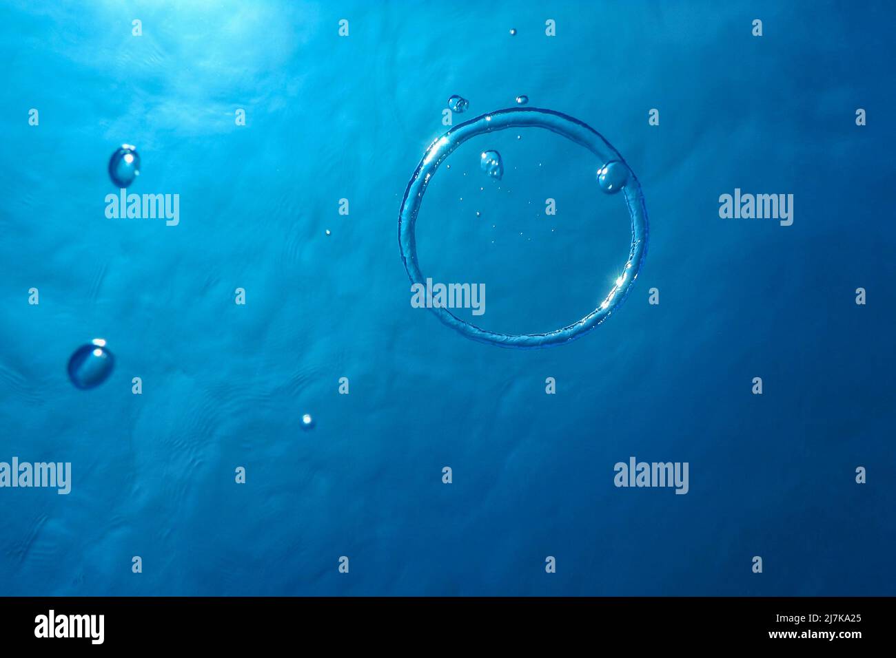 Underwater Bubble Ring Ascends towards the Sun Stock Photo - Alamy
