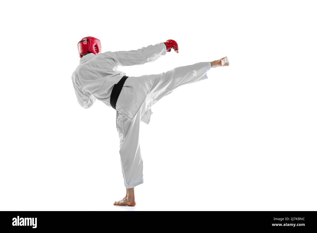 Back view. Portrait of young sportive man wearing white dobok, helmet ...