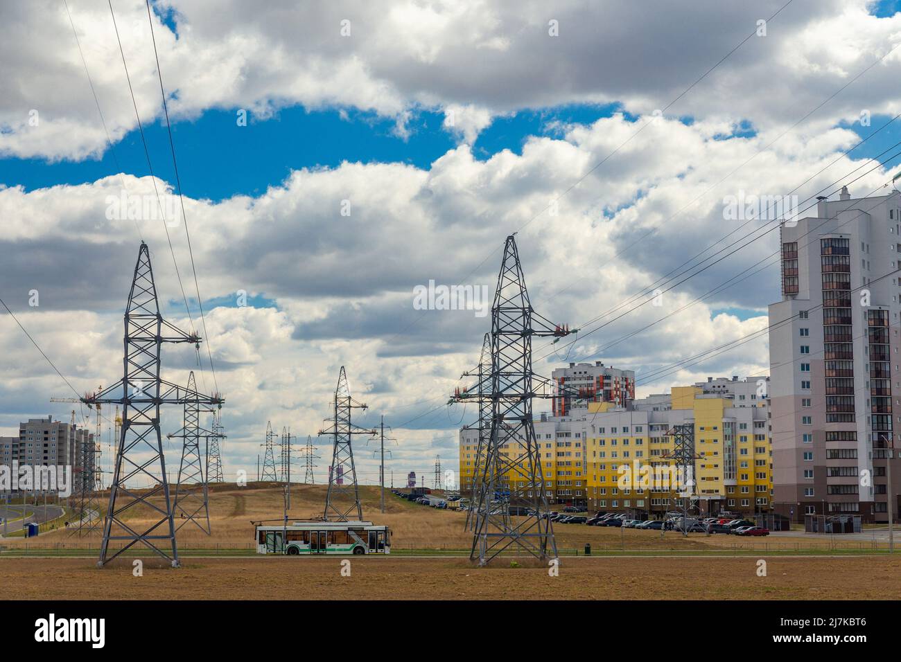 Power lines in the city near residential buildings against a blue sky ...