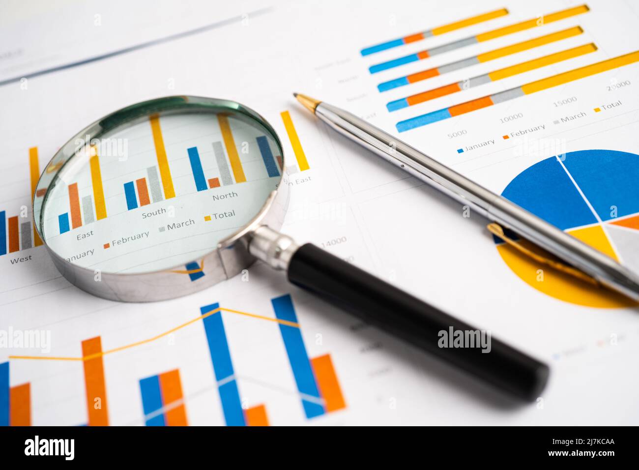 Magnifying glass on charts graphs paper. Financial development, Banking ...