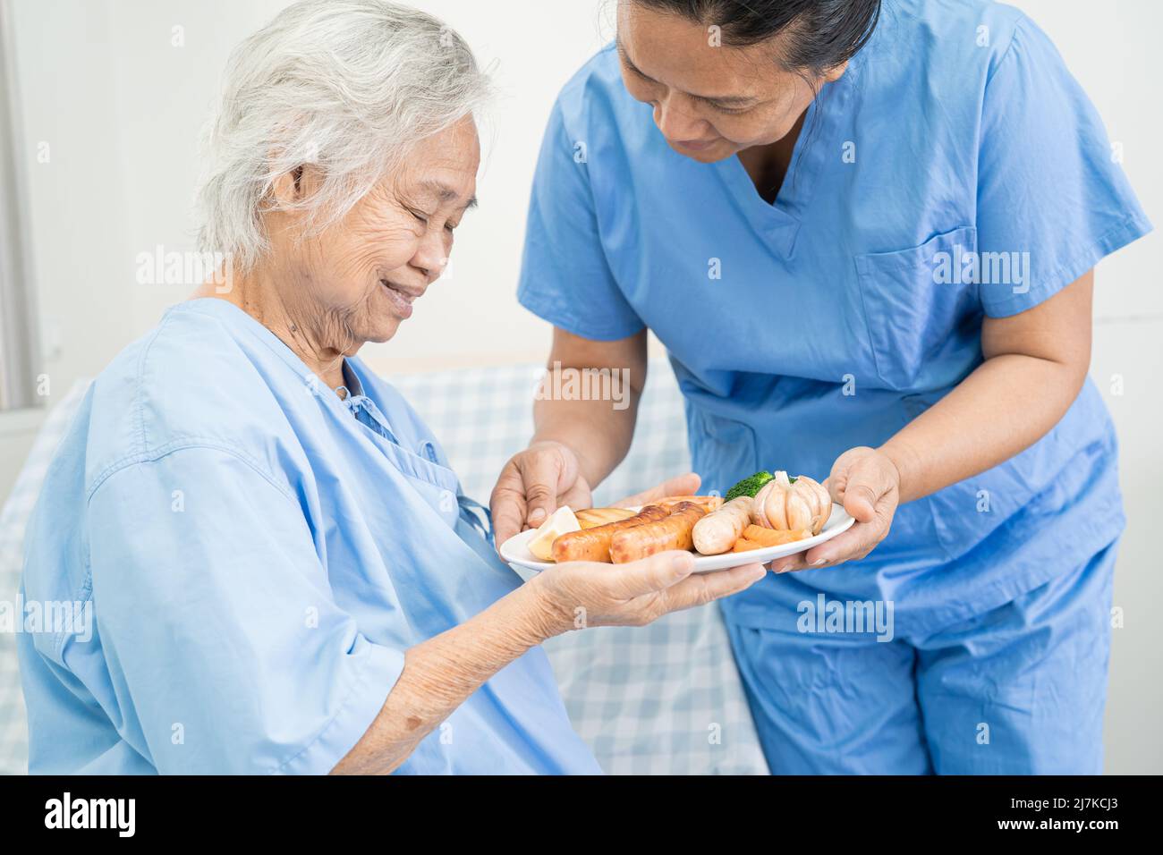 Asian senior or elderly old lady woman patient eating breakfast and ...