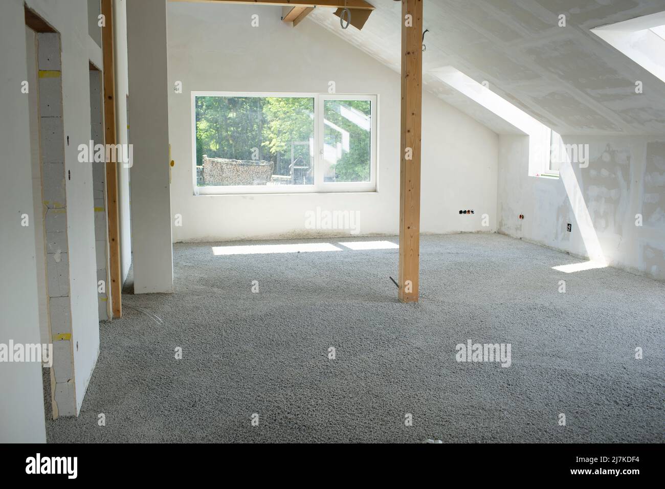 Construction site of attic conversion in the phase of floor screed fill ...