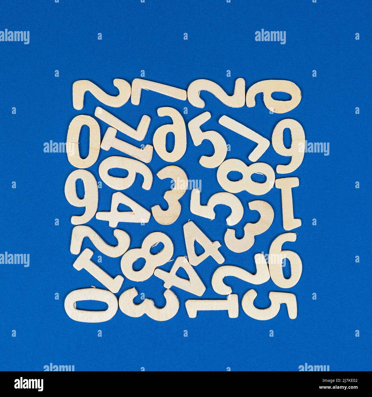 the shape of the square formed with wooden numbers on a blue background ...