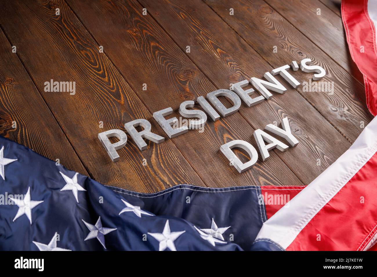 words presitdents day laid with silver letters on wooden surface near ...
