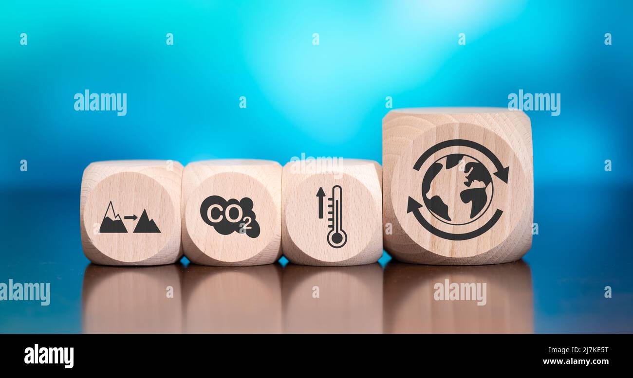 Wooden blocks with symbol of climate change concept on blue background ...