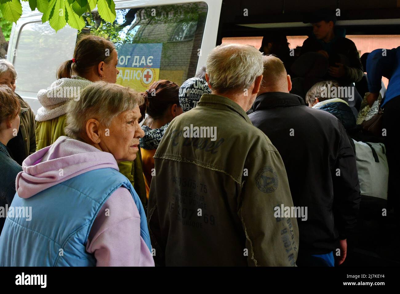 People are seen standing in a line while waiting for their turn to ...
