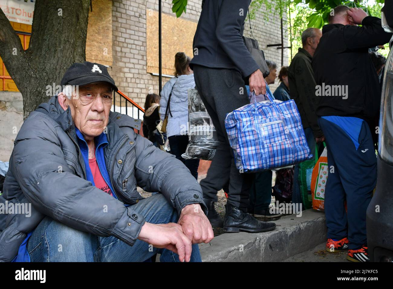 An old man seen waiting for her turn to board an evacuation bus from ...