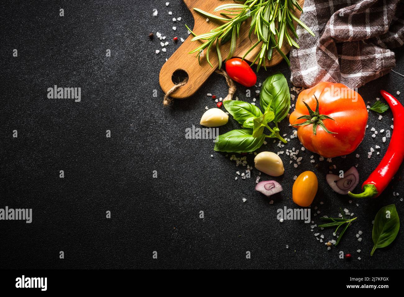 Food cooking background on black stone table Stock Photo - Alamy