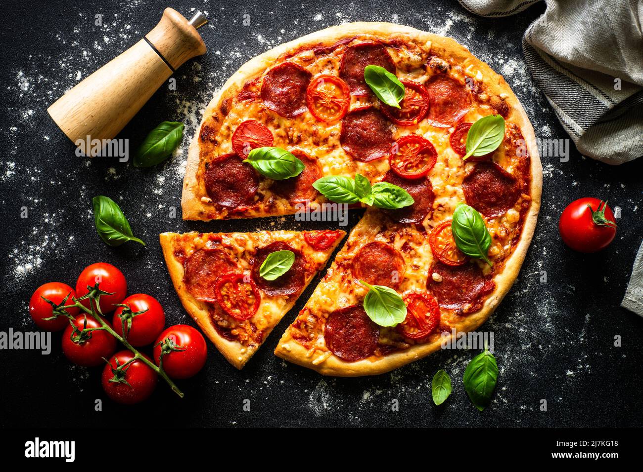 Traditional italian pizza with salami cheese, tomatoes and basil Stock ...