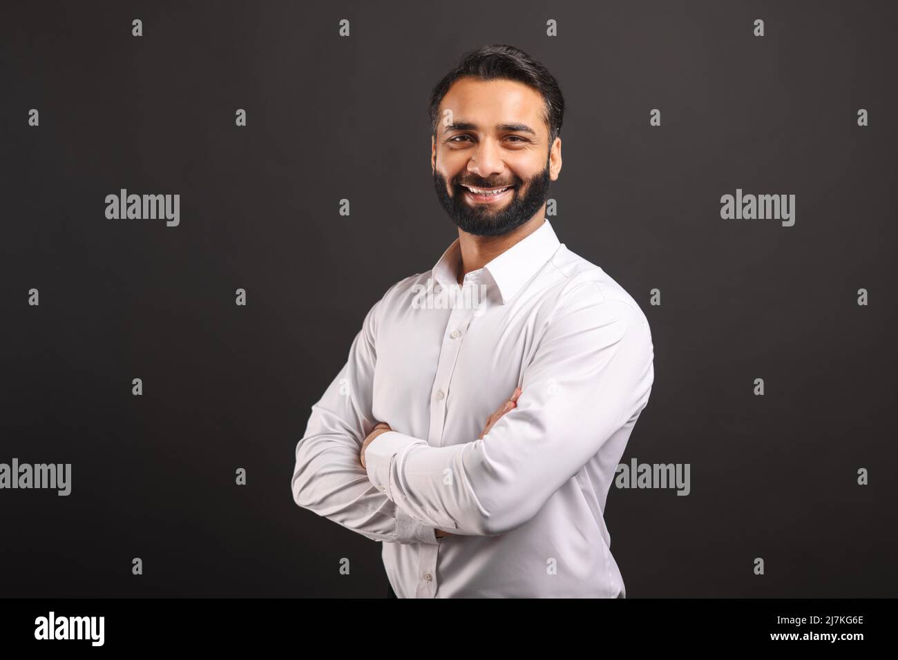 Proud Indian male businessman in white smart casual shirt stand with ...