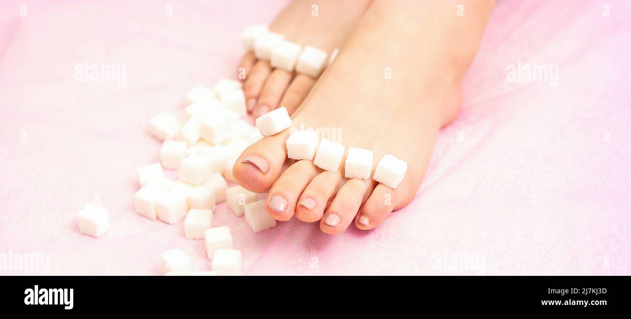 The concept of epilation, waxing. Sugar cubes lying down in a row on ...