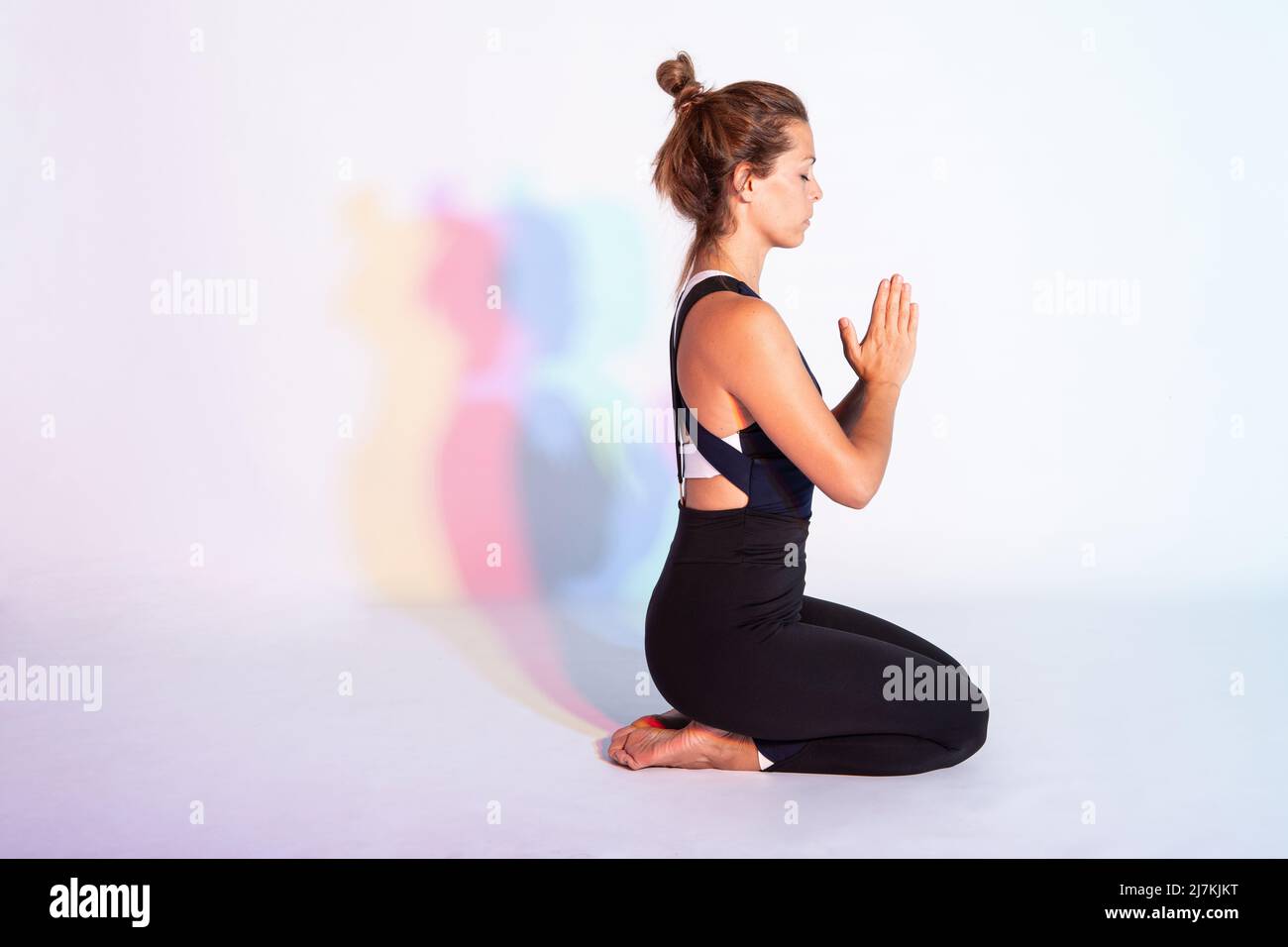 Full body of peaceful female with closed eyes meditating in Padmasana ...