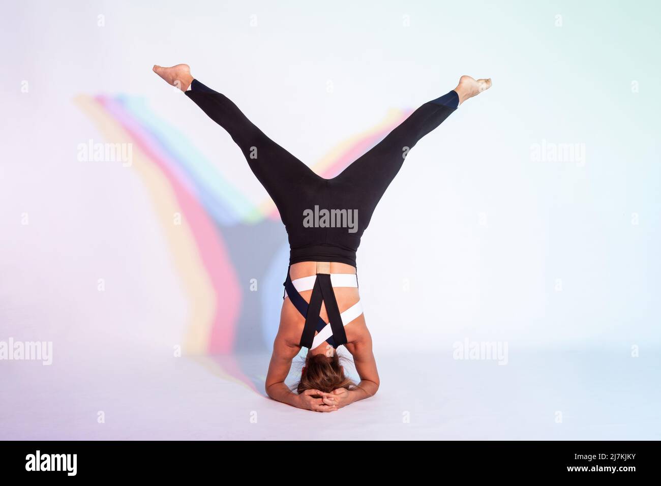 Female courier in uniform and mask using smartphone and pushing button ...