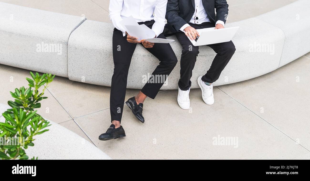 From above cropped unrecognizable multiracial male coworkers in formal ...