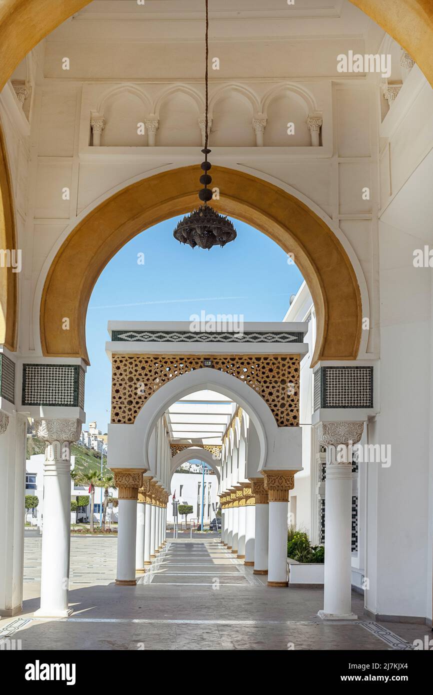 Long empty pathway between columns with ornamental elements and arched ...