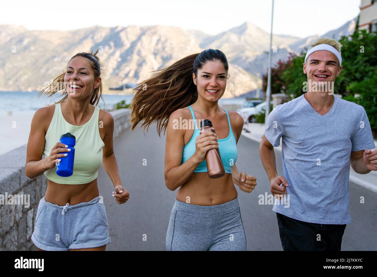 Group of friends fitness training together outdoors living active ...