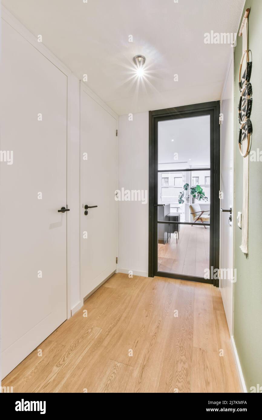 Light corridor with bright glowing lamp and glass entrance door of ...