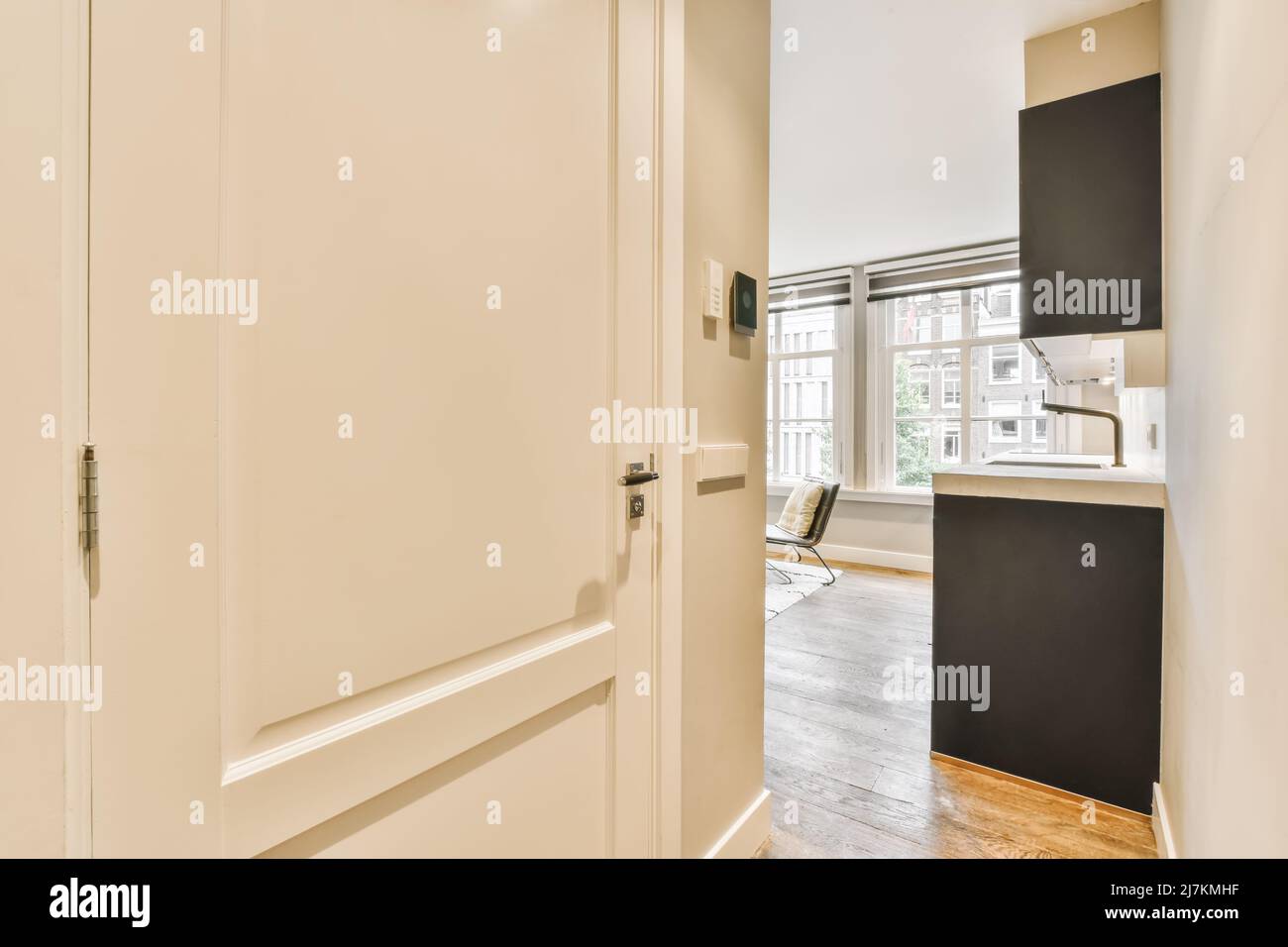 Closed white room doors with stainless handles in light narrow hallway ...