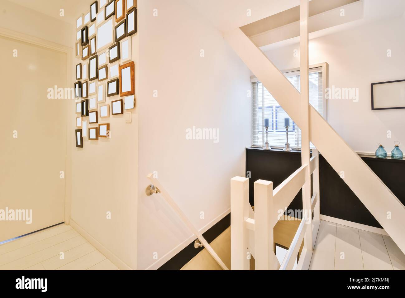 Light corridor with many empty frames on wall on second floor of new ...