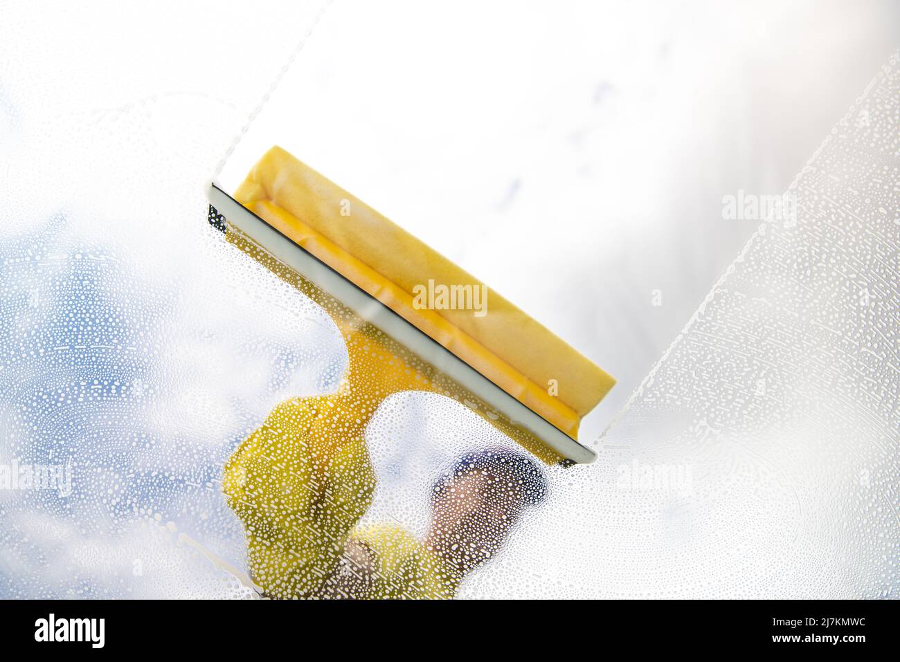 window cleaner cleaning window with squeegee and wipe Stock Photo - Alamy