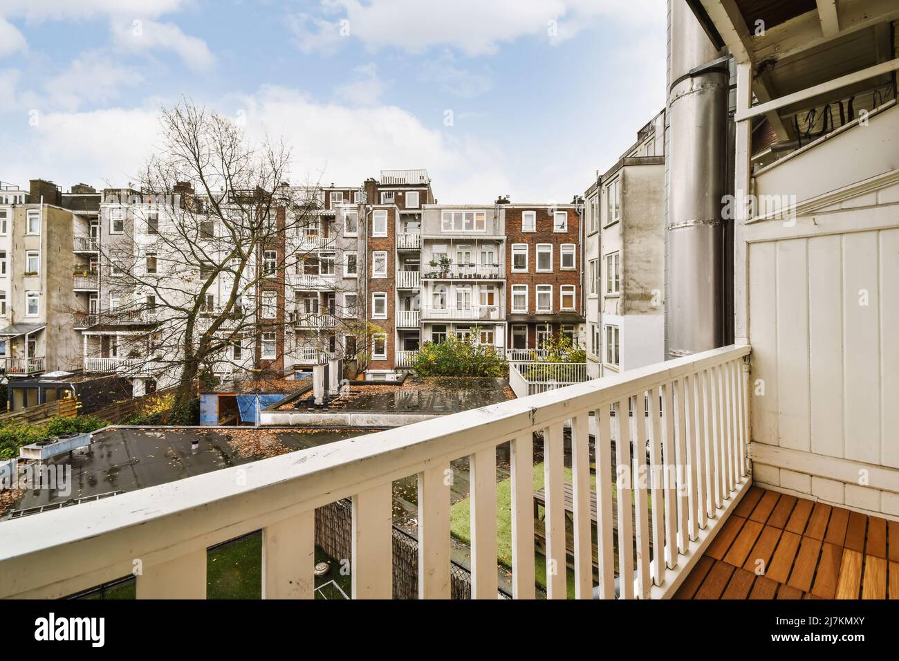Balcony of residential building with glass doors with reflection and ...