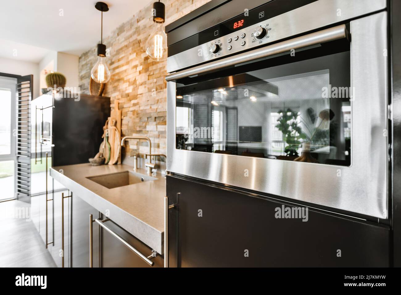 Contemporary built in ovens placed near counter in modern kitchen with ...