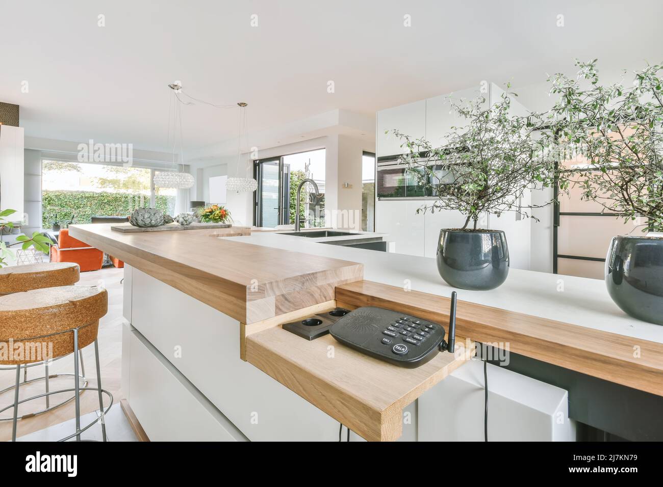 Wooden counter with wireless intercom system and vases with decorative ...