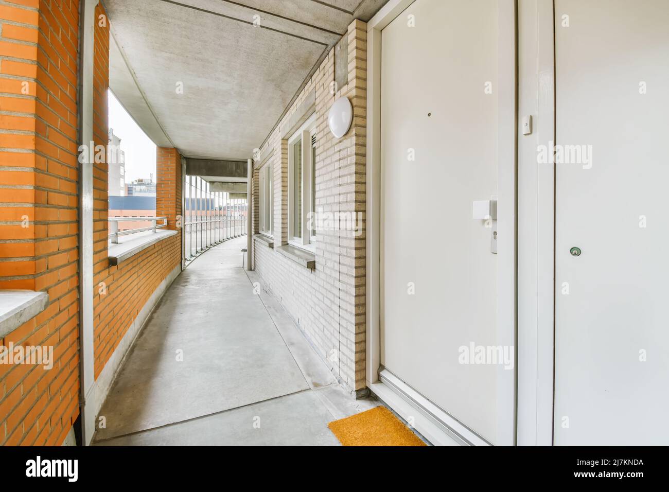 Narrow passage on terrace in modern residential building with brick ...