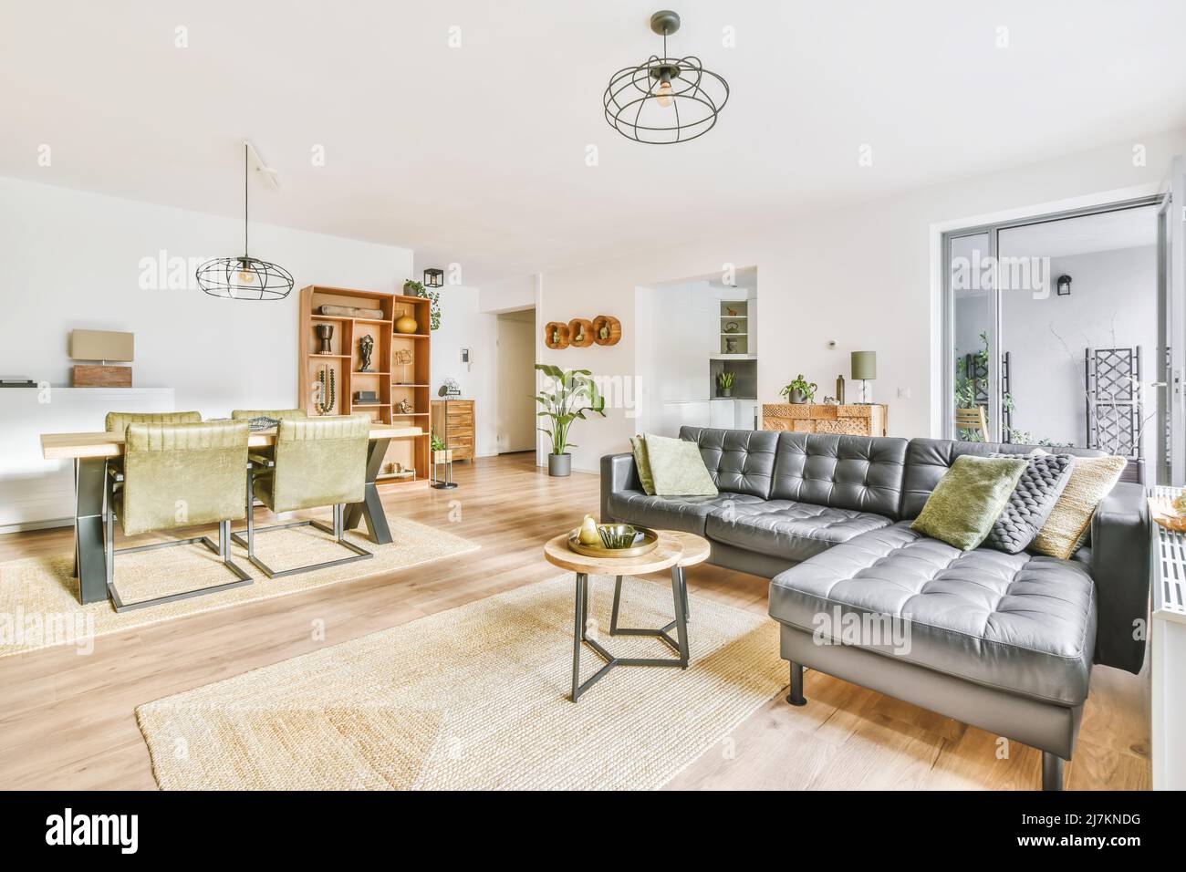 Dining table and comfortable couch placed against TV on cabinet in ...