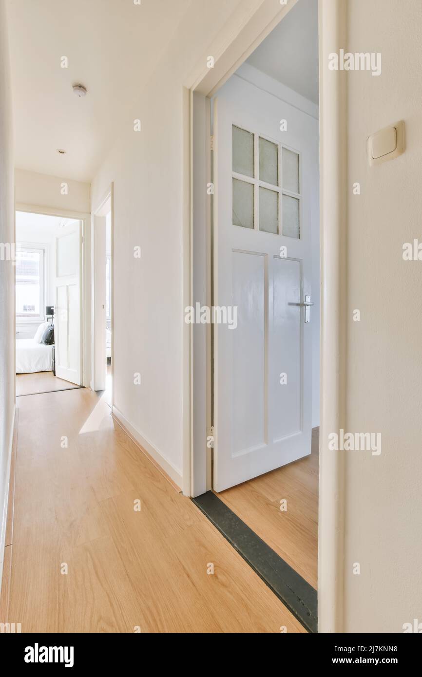 Corridor with entrance door and parquet floor in contemporary flat with ...