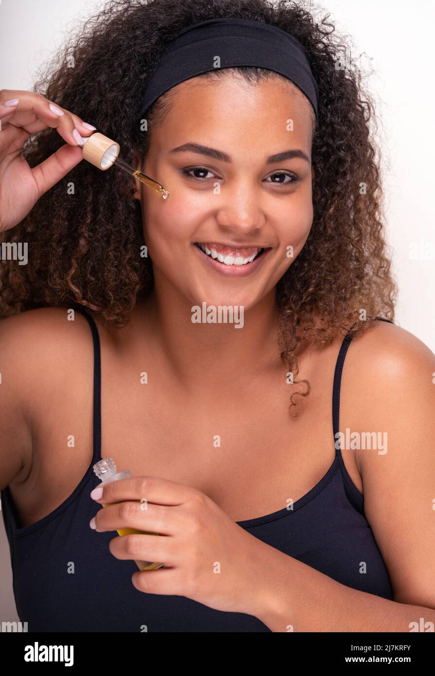 Gorgeous smiling young Hispanic female model with perfect skin and long ...