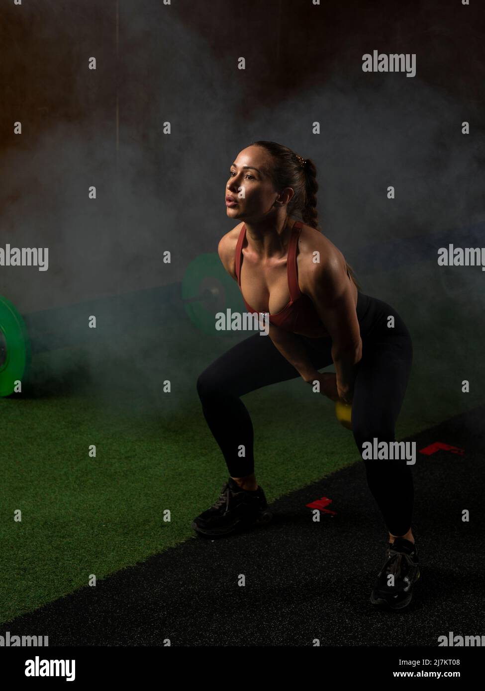 Full body of determined young muscular female athlete in activewear ...