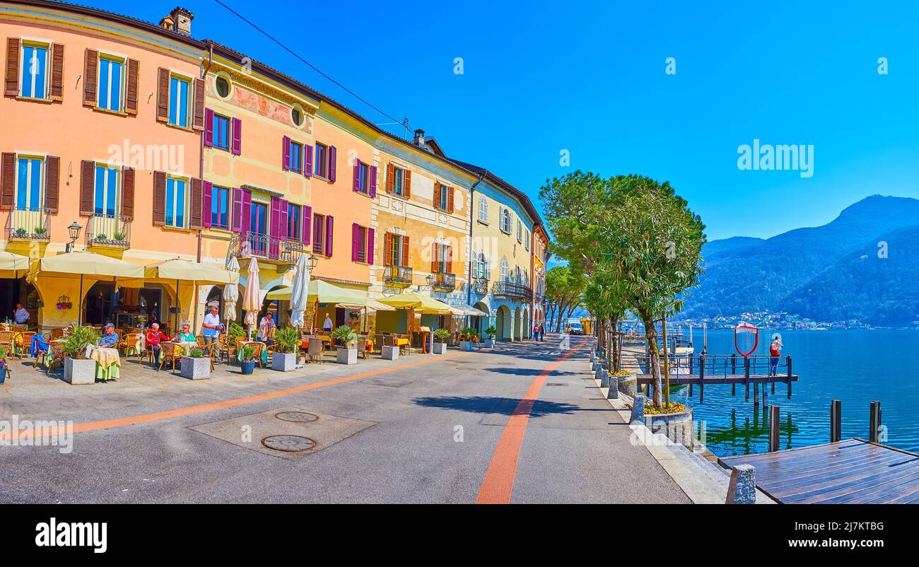Panorama of Lake Lugano embankment with green trees, flower beds ...