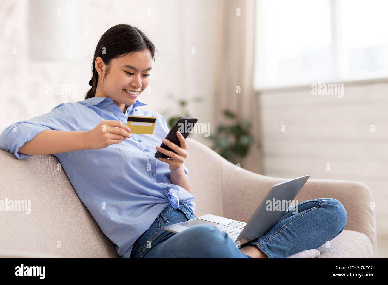 Happy asian woman freelancer banking online, using smartphone Stock ...